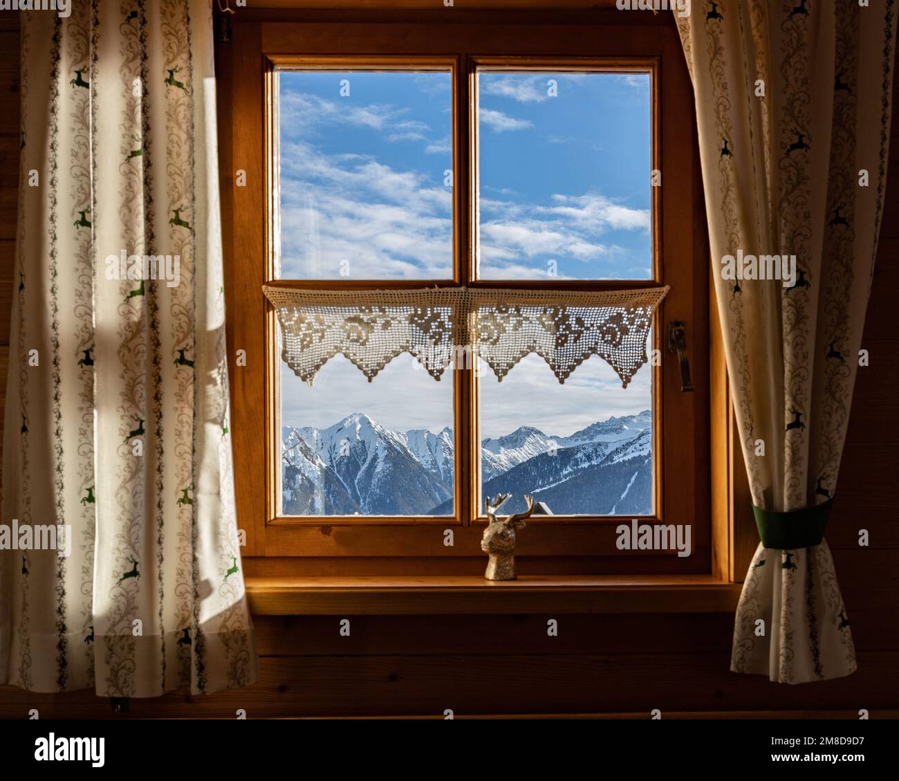 Morning view of the mountains through a window in a mountain hut ...