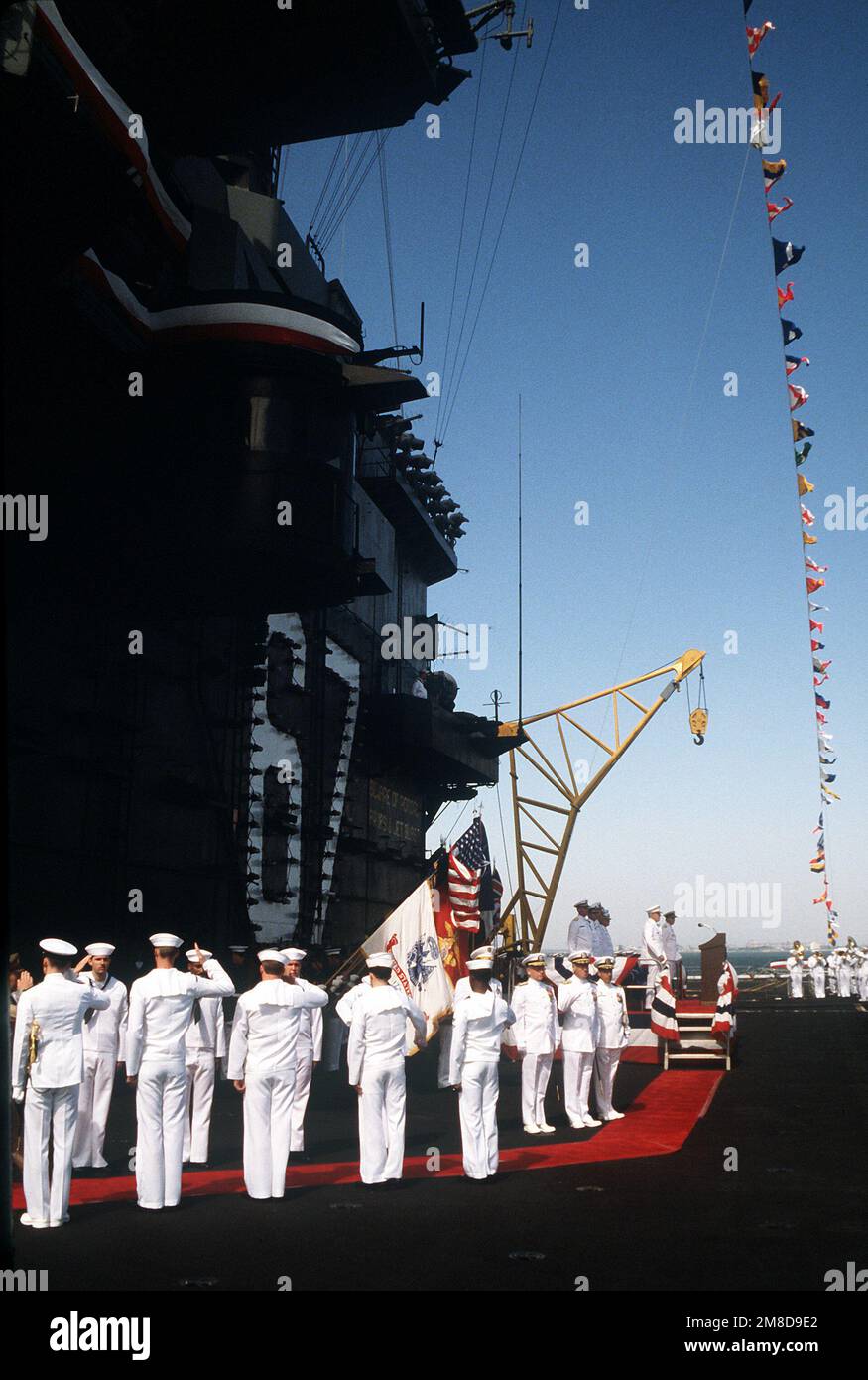Sailors render honors at the ceremony aboard the aircraft carrier USS ...