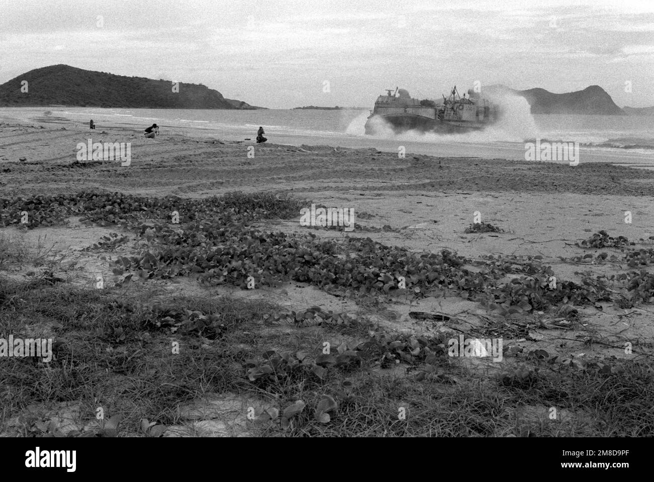 Photographers take pictures as members of the 3rd Marine Expeditionary ...