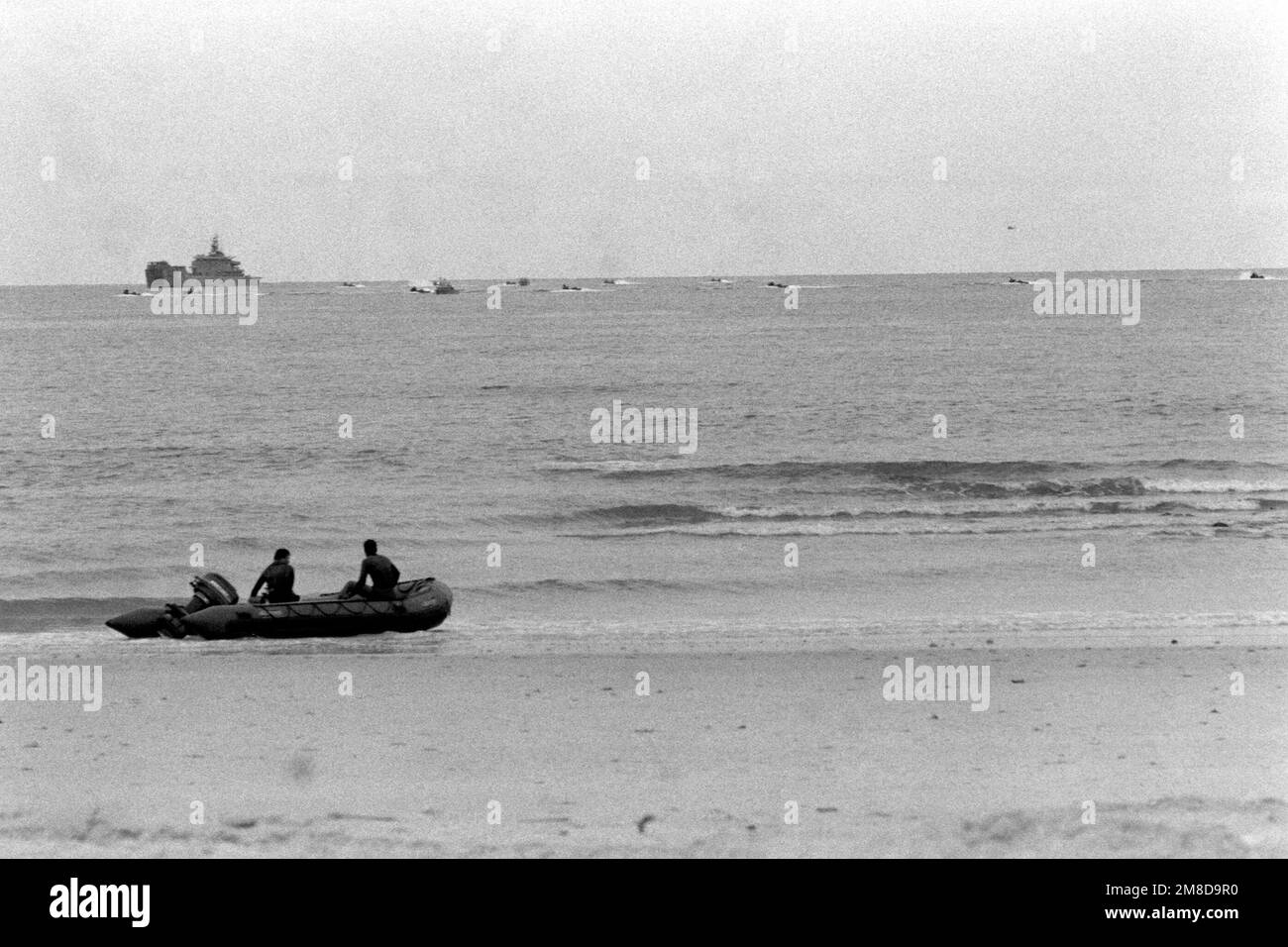 Marines man an inflatable assault boat on the beach during Cobra Gold ...
