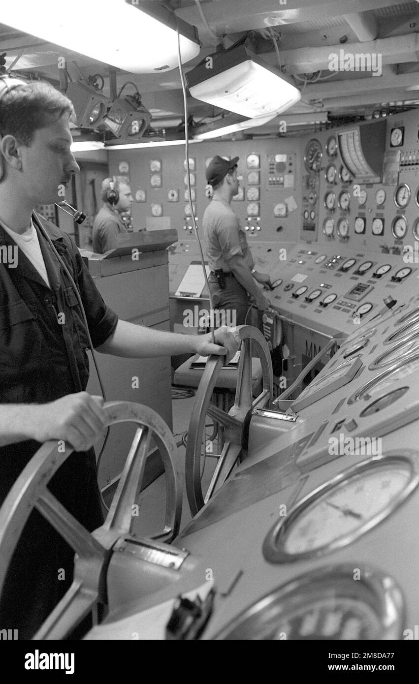 Sailors monitor instrument consoles in an engineering space aboard the ...