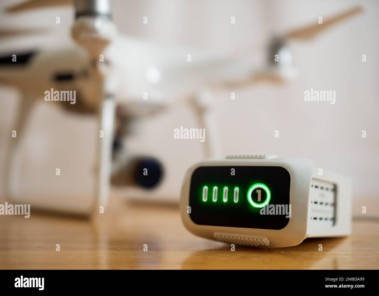 Drone intelligent lithium-polymer battery charging on wood desk with ...