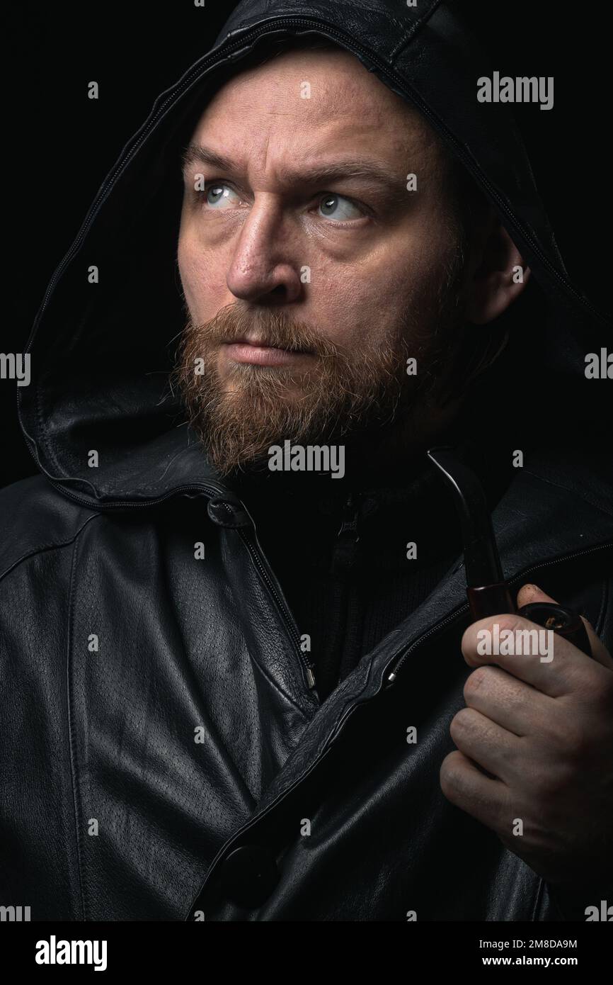 Portrait of a Bearded man in Black Rain Jacket Smoking a Pipe Stock ...
