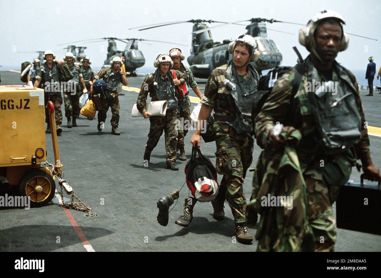 Navy personnel wearing camouflage utility uniforms are led to a ...