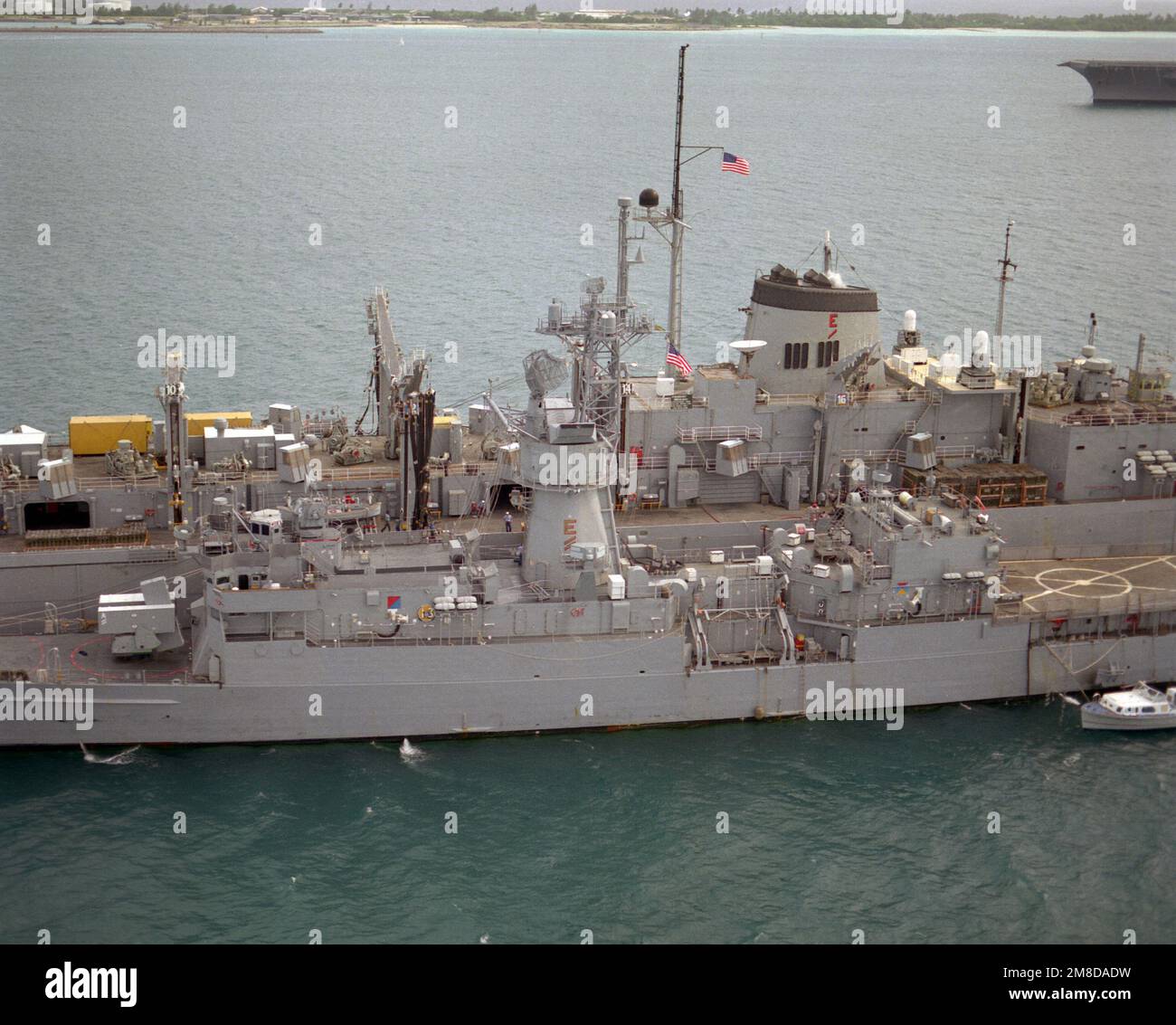 A starboard amidships view of the frigate USS COOK (FF-1083) moored ...