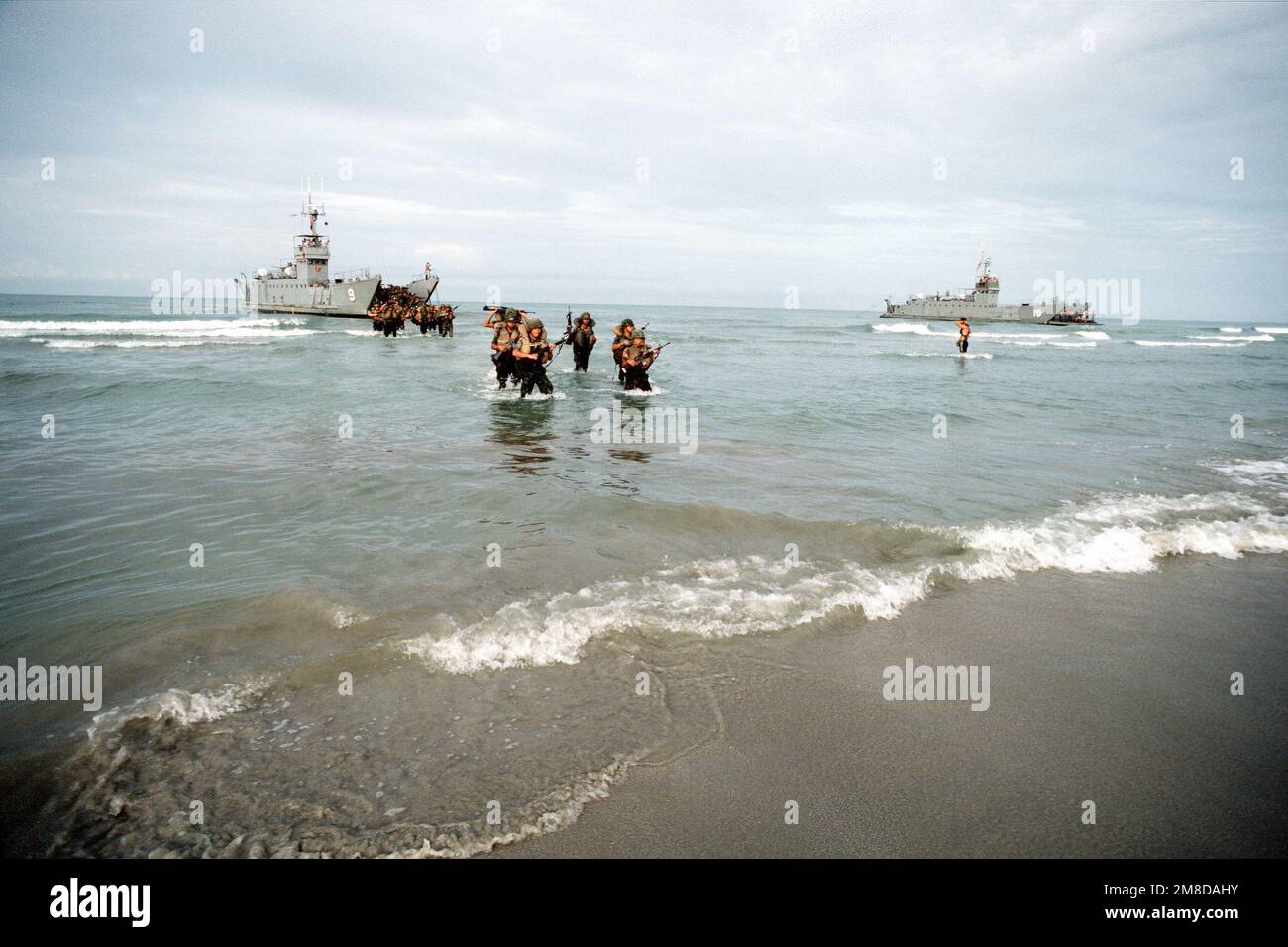 Thai marines wade ashore from the Royal Thai Navy utility landing craft ...