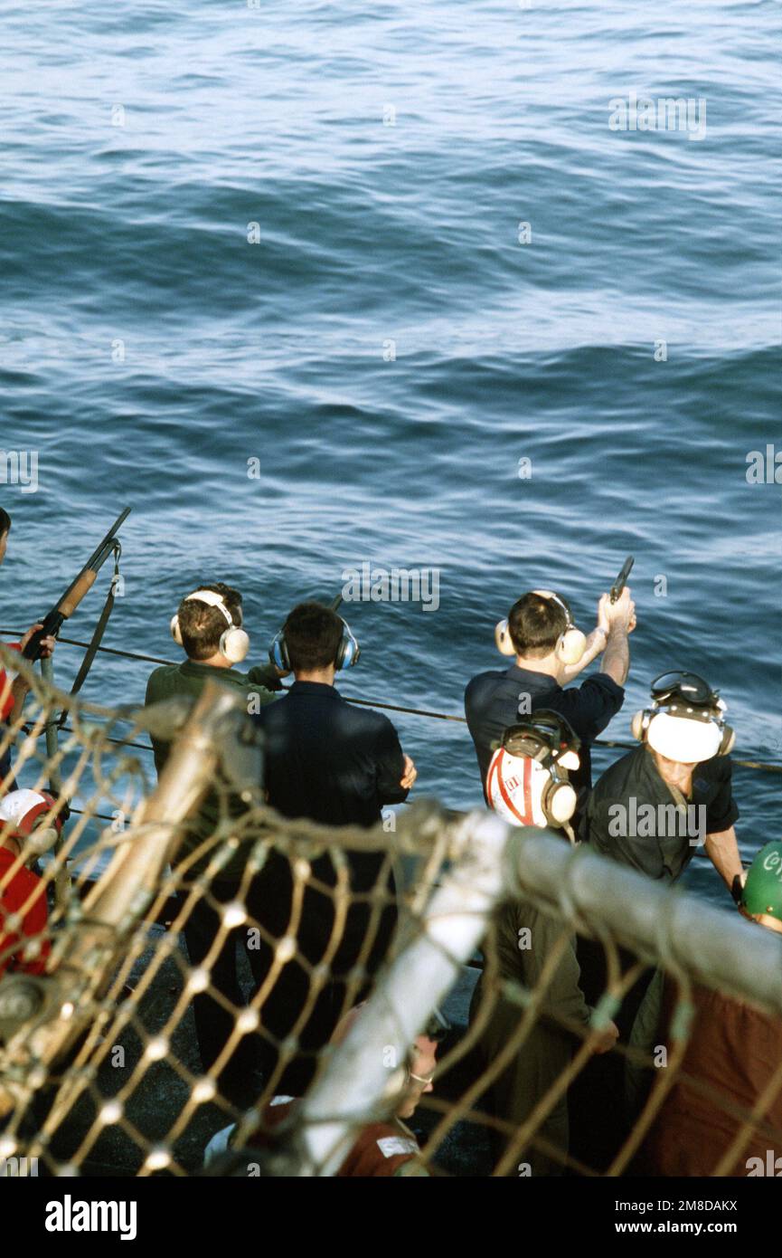 Marines and sailors fire M-1911 .45-caliber pistols and a 12-gauge ...