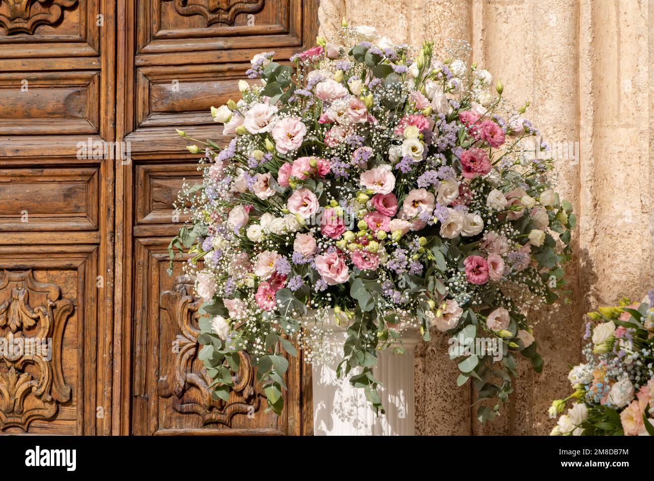 Luxury wedding floral decorations at the entrance of Ostuni church ...