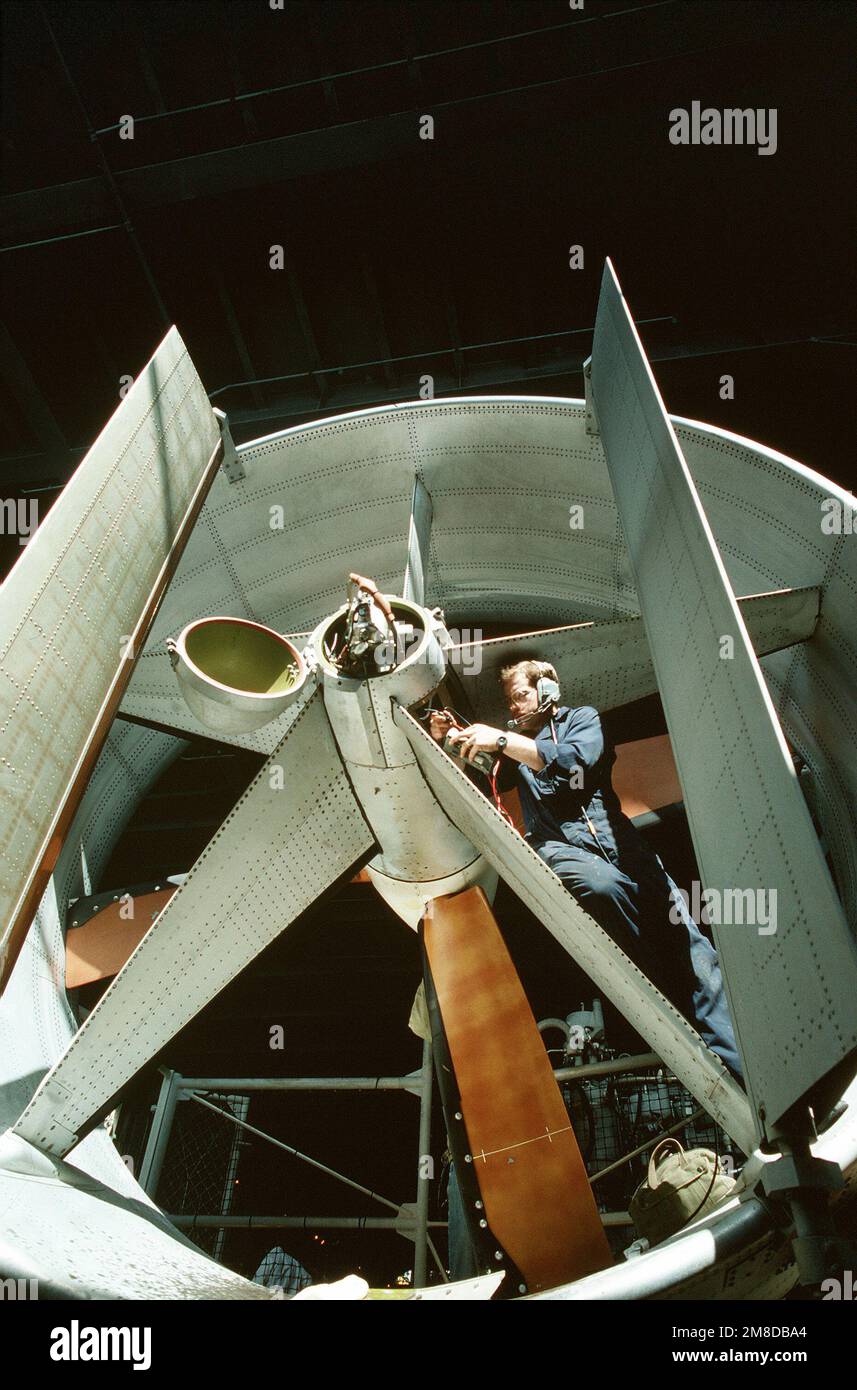 Gas Turbine Systems (E) 2nd Class Don Hainline uses a chip detector to ...