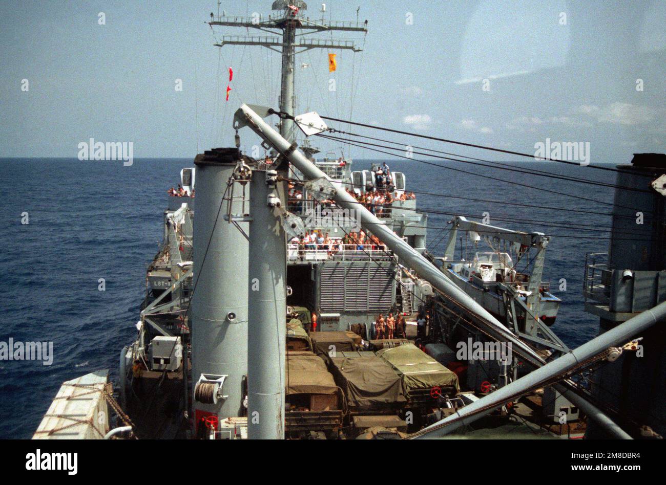 Off-duty sailors and Marines congregate on the weather decks aboard the ...