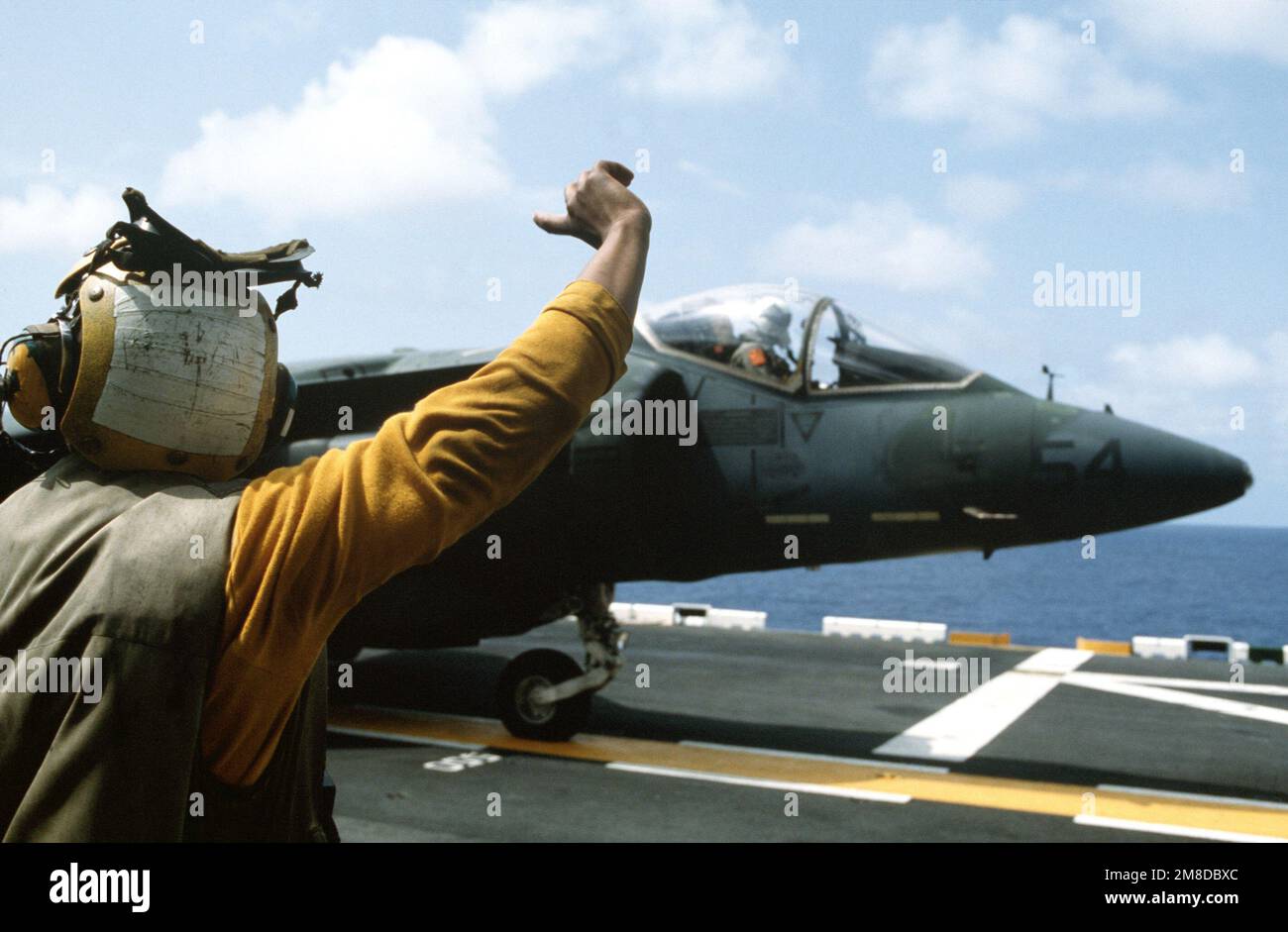 A plane director on the flight deck of the amphibious assault ship USS ...