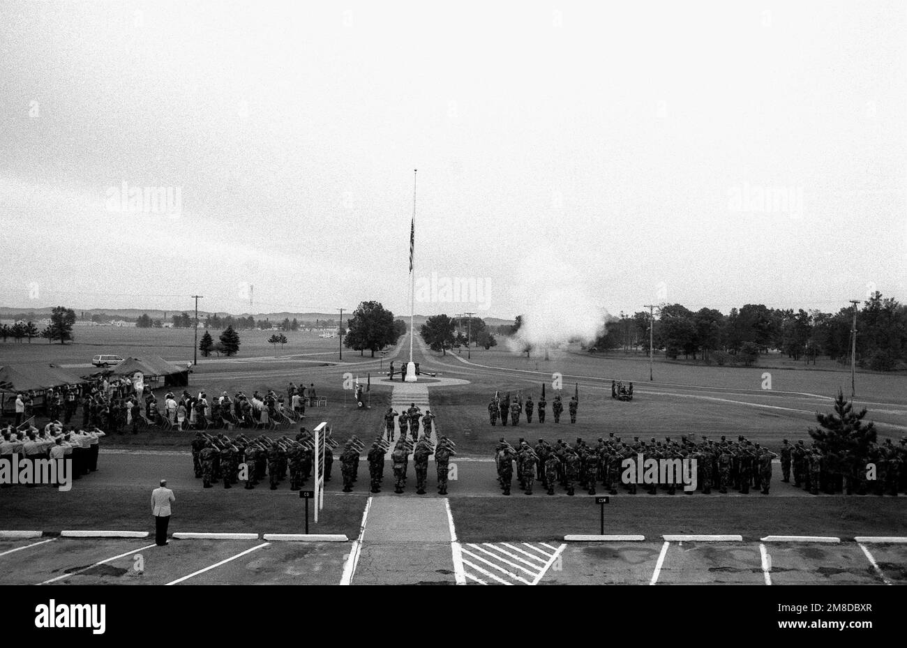 A saluting cannon is fired as soldiers and guests render honors during ...