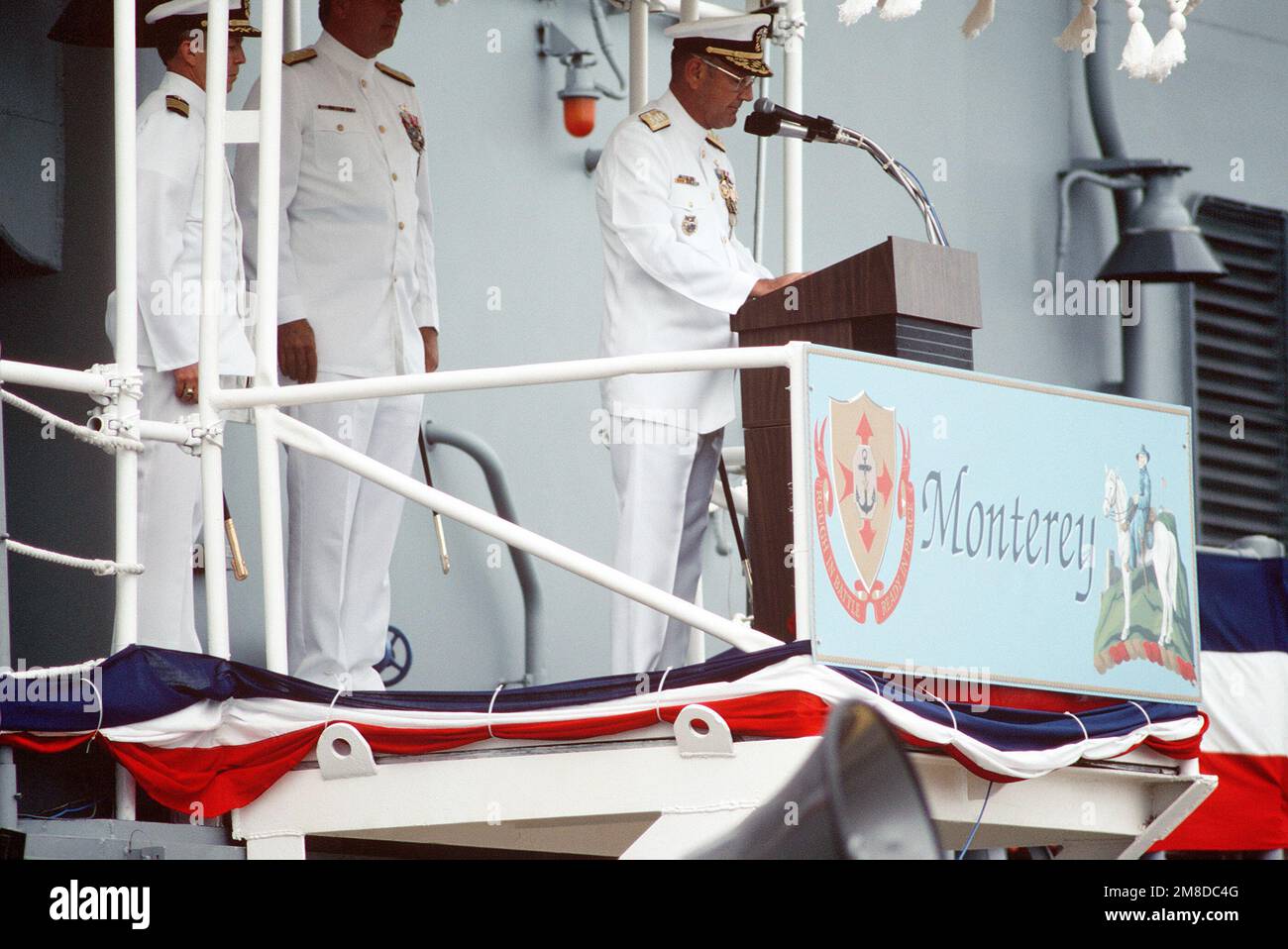 An admiral speaks at the commissioning of the guided missile cruiser ...
