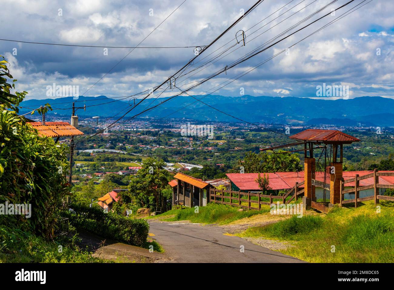 Beautiful mountain landscape and city panorama with forest trees clouds ...