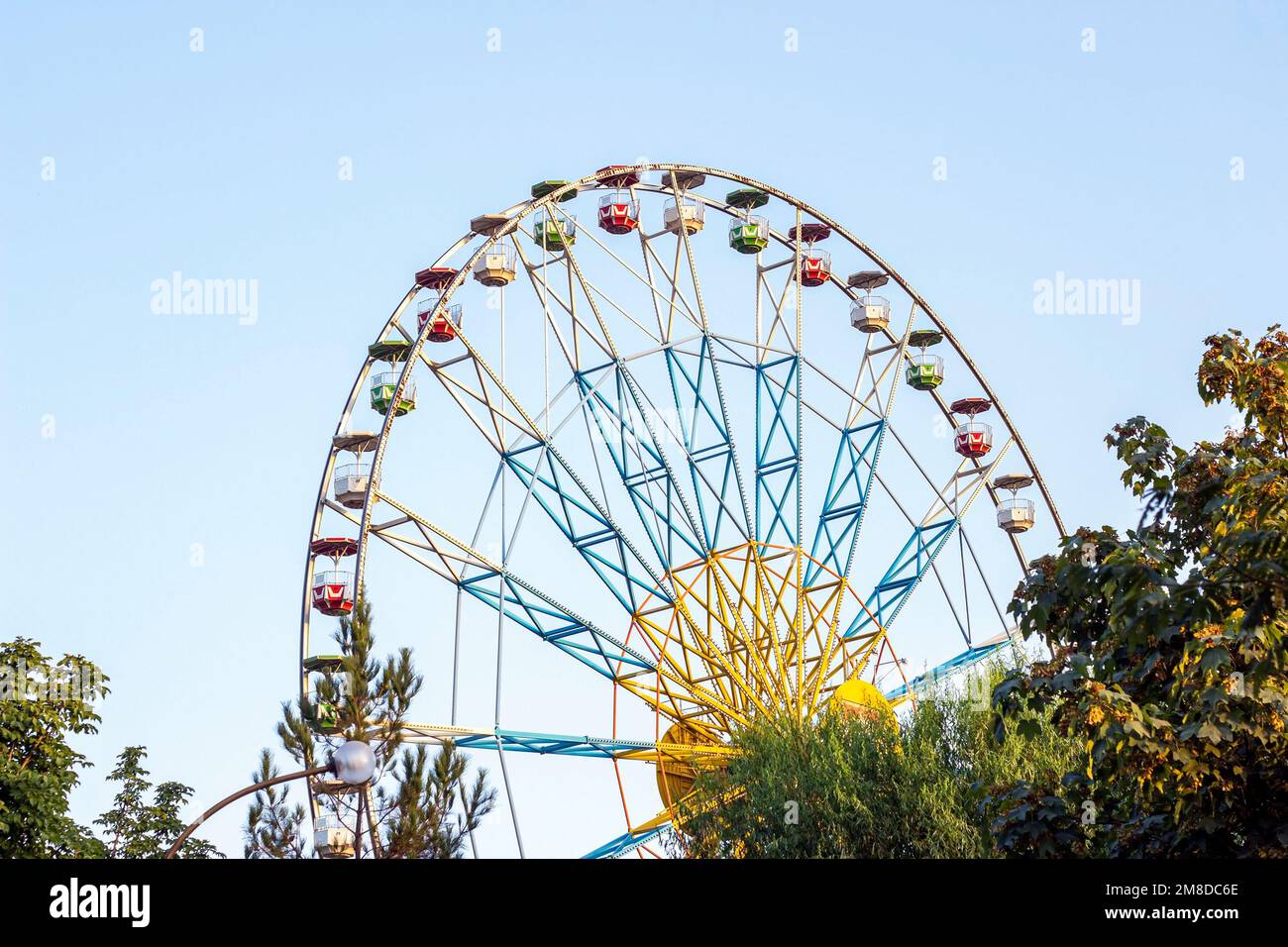 High carnival Ferris wheel in the amusement park in summer spinning ...