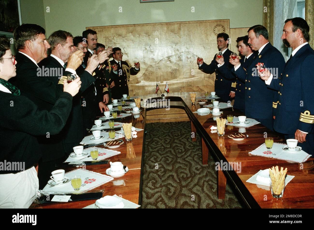 U.S. Navy and Polish navy officers toast each other during a meeting ...