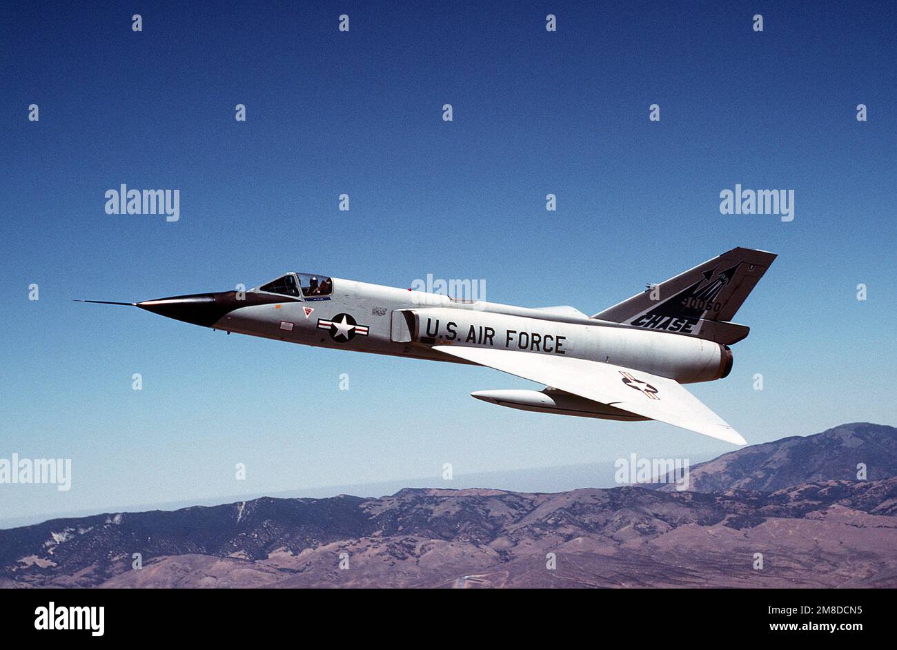 An F-106A Delta Dart aircraft passes over the Mojave Desert while en ...