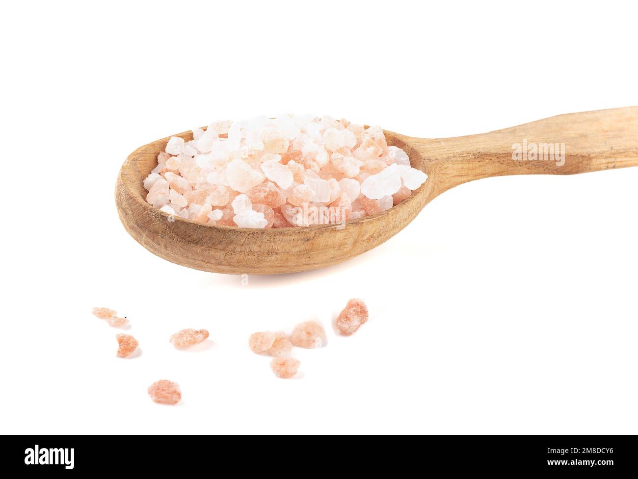 Large crystals of Himalayan pink salt in a wooden spoon and on a white ...
