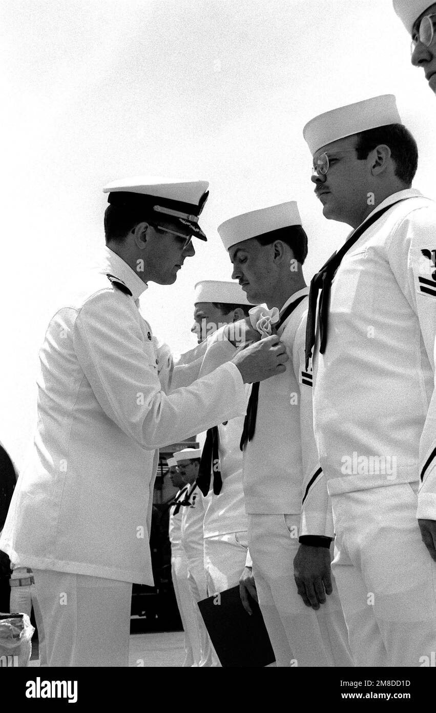 The commanding officer conducts a dress white inspection of his crew on ...