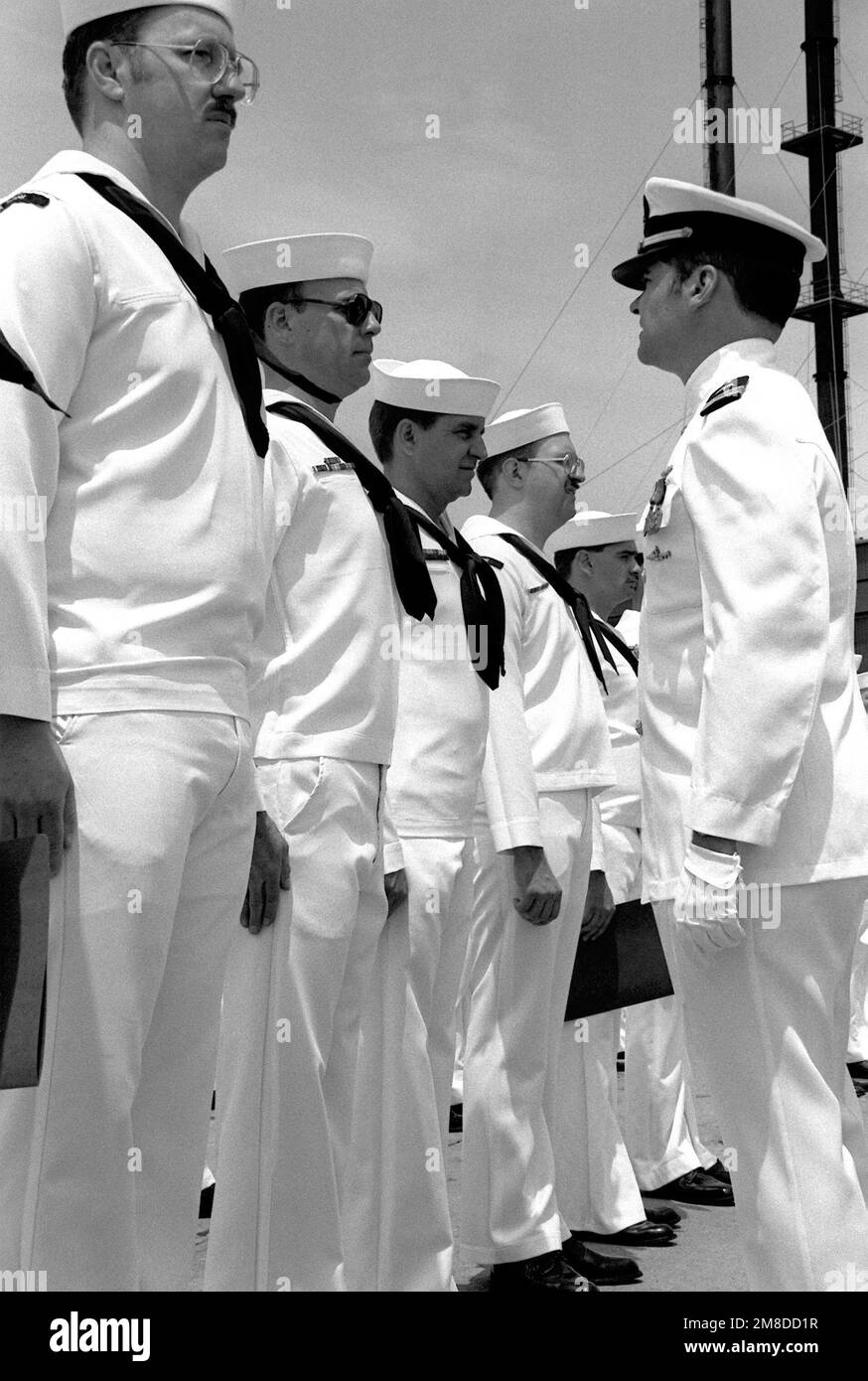 A junior officer accompanies the commanding officer as he conducts a ...