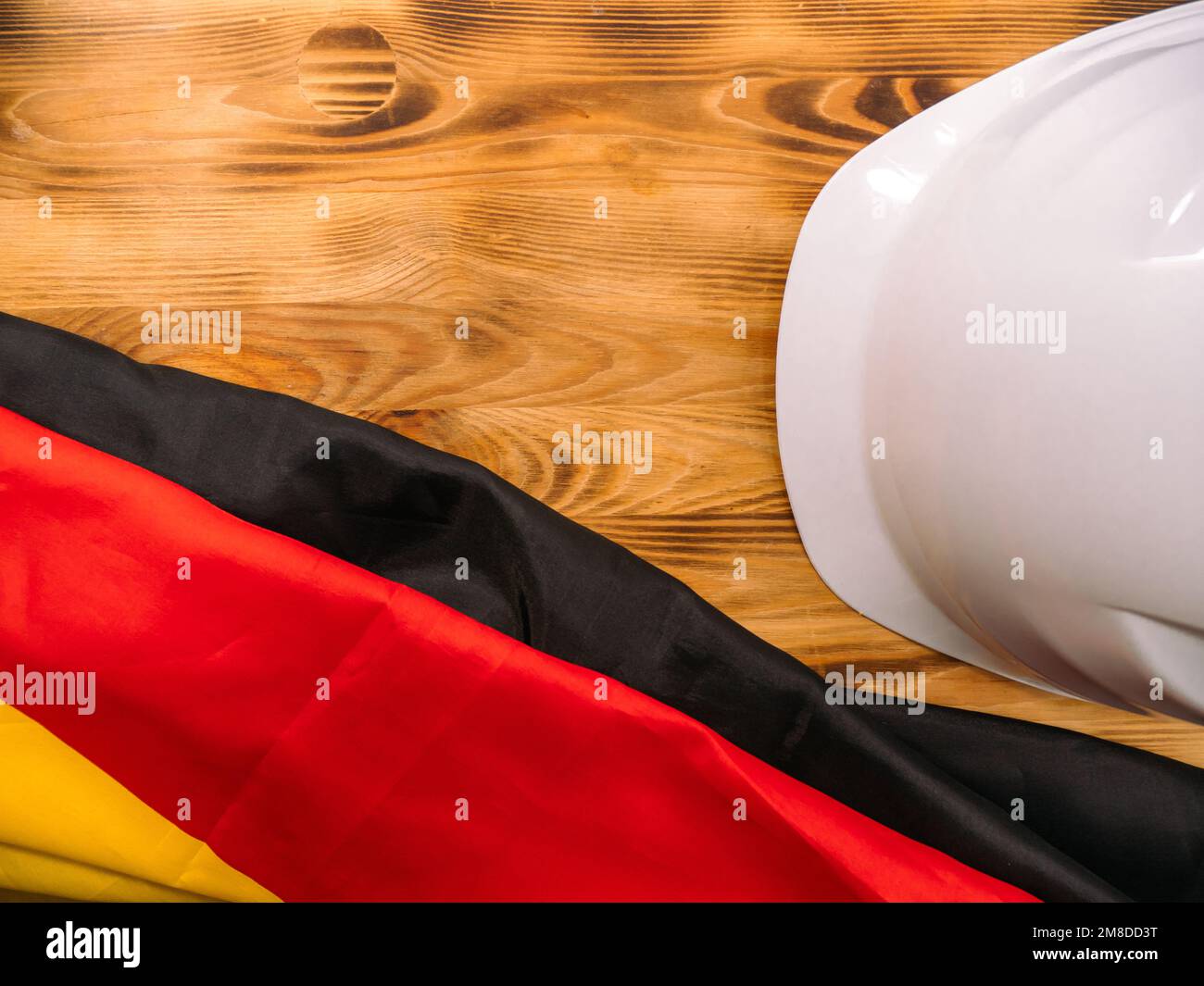 German flag and construction helmet on a tree. Concept Made in Germany ...