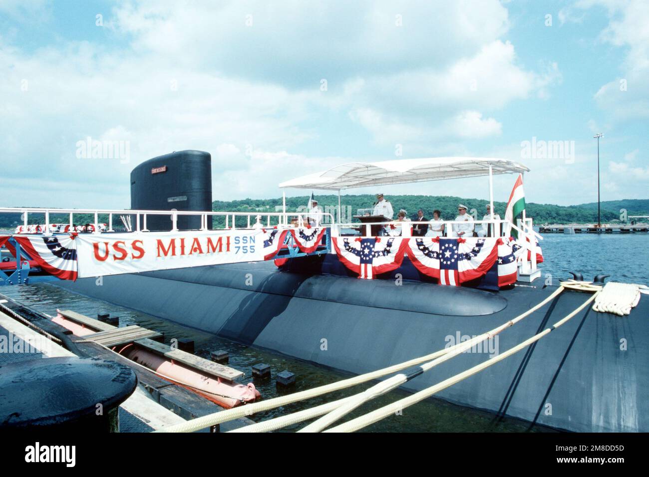 A flag officer speaks during the ship's commissioning ceremony of the ...