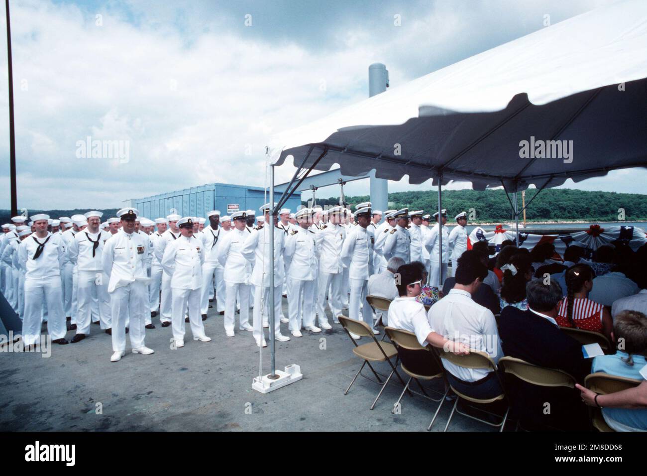 Officers and crew members stand in formation during the commissioning ...