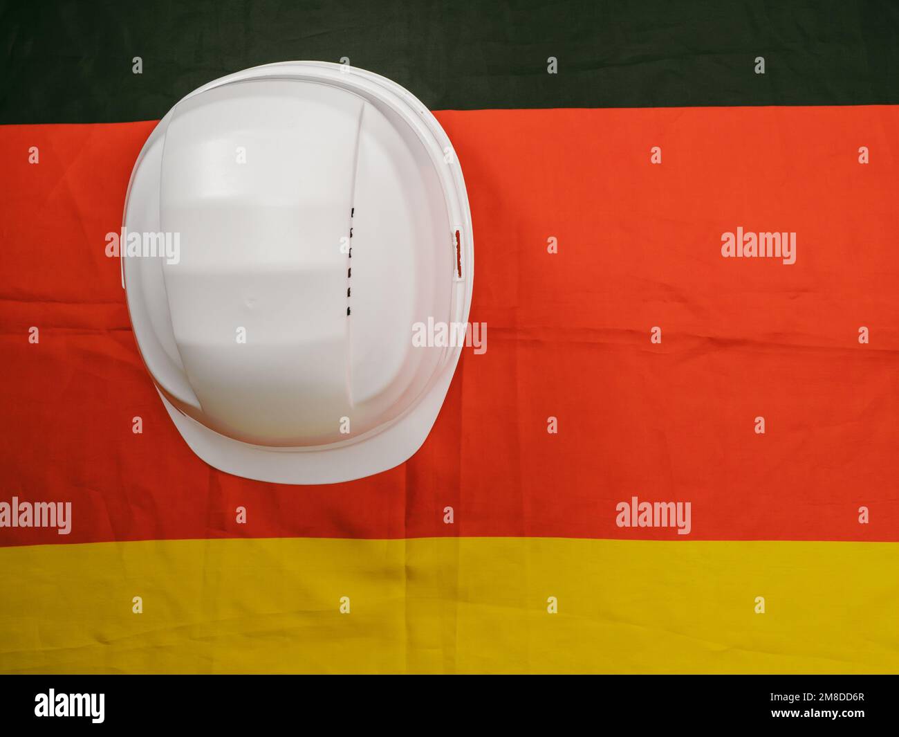 German flag and construction helmet. Concept Made in Germany. German ...