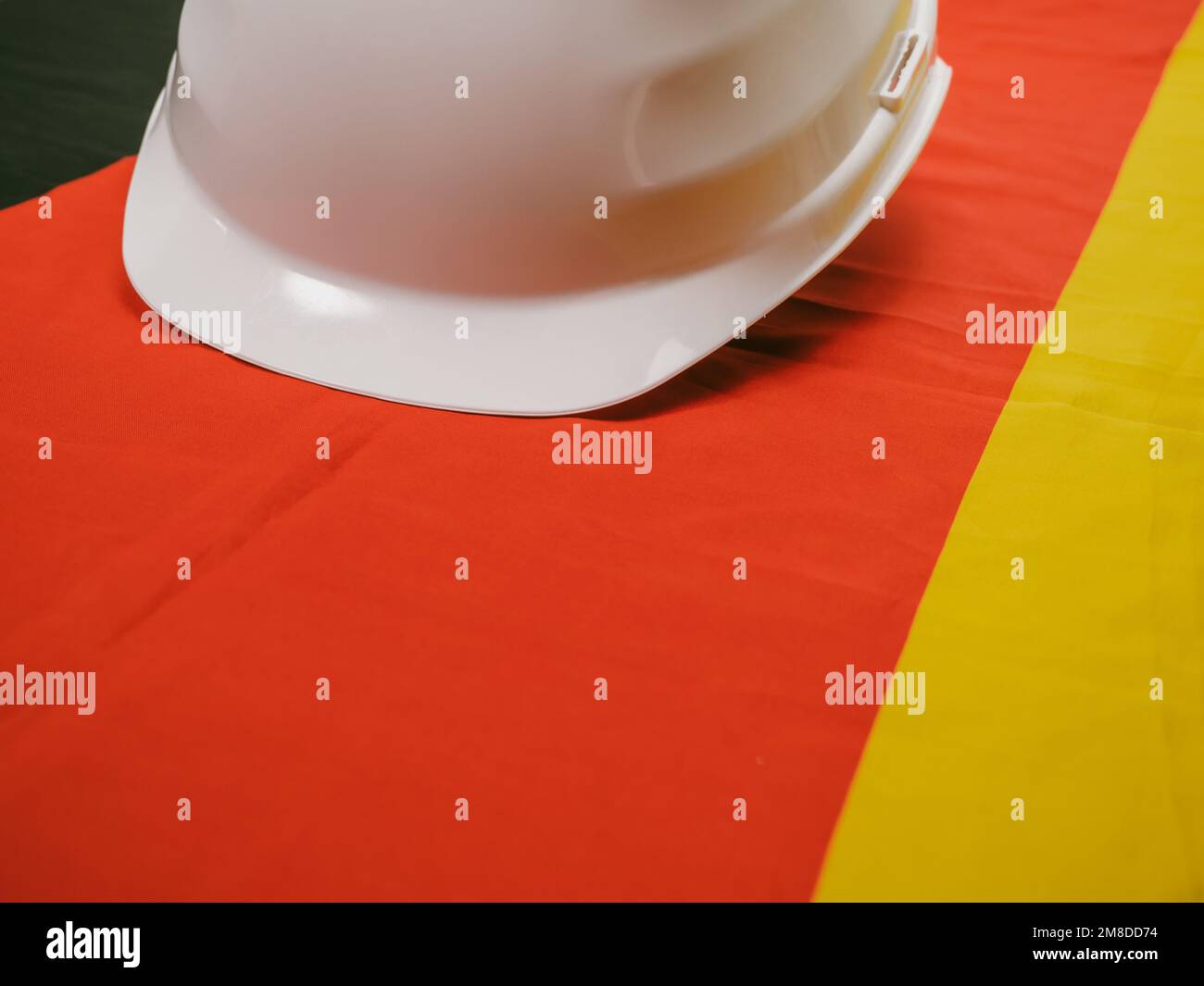German flag and construction helmet. Concept Made in Germany. German ...