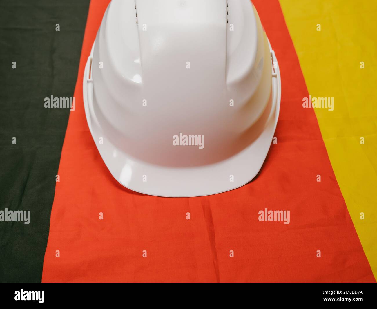 German flag and construction helmet. Concept Made in Germany. German ...