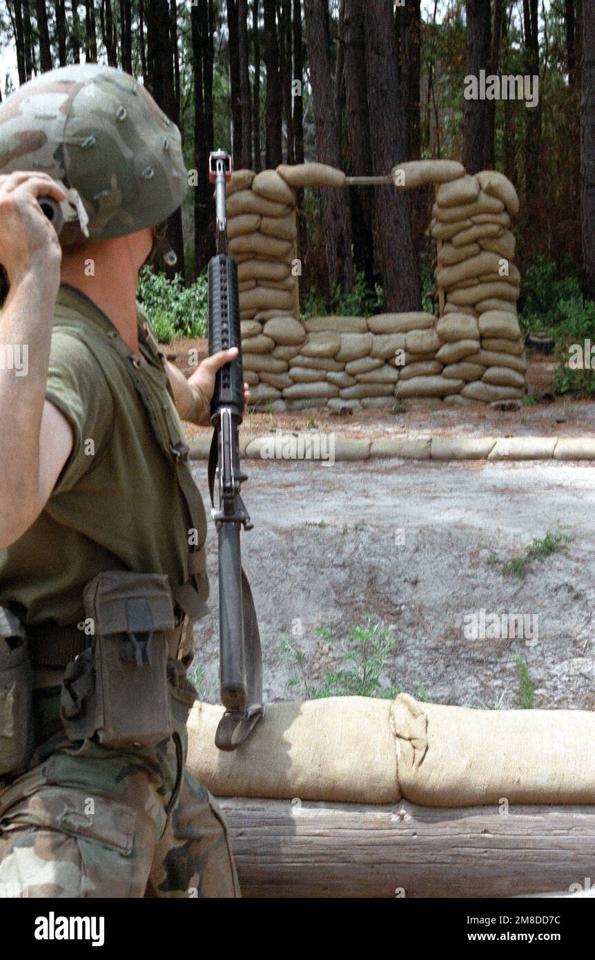 A 1ST Battalion recruit armed with an M-16A2 rifle prepares to throw a practice grenade during ...