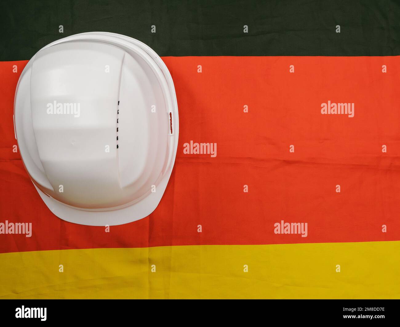 German flag and construction helmet. Concept Made in Germany. German ...