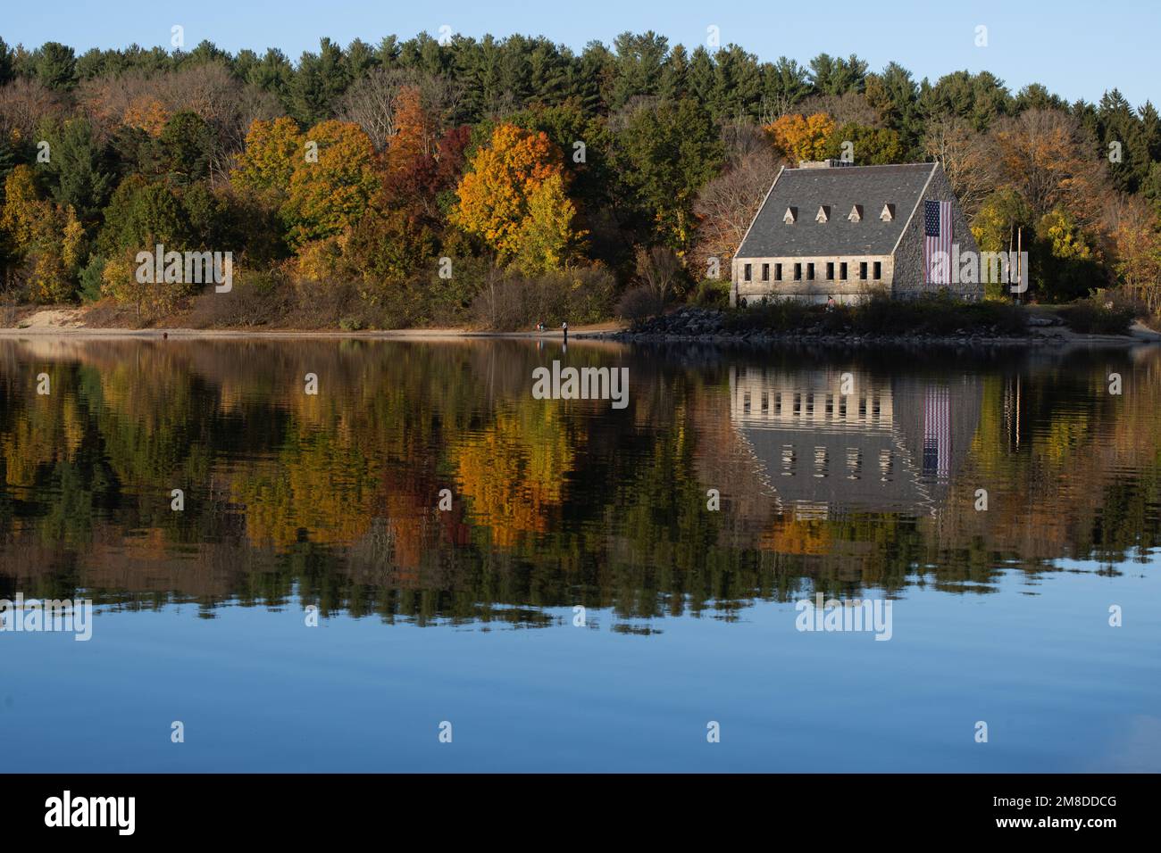 A beautiful view of a house with american flag by the lake Stock Photo ...
