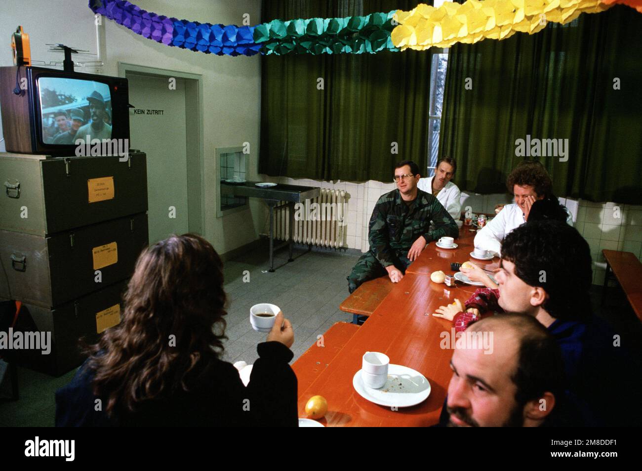 TSGT Ervin Burke chats with East German refugees at the 652nd U.S. Air ...