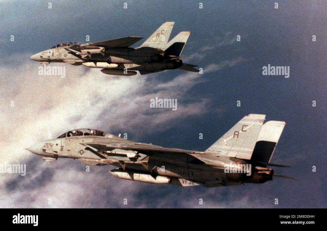 Two Fighter Squadron 32 (VF-32) F-14A Tomcat aircraft bank into a turn ...