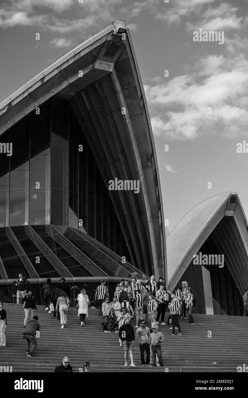 A vertical shot of people standing in front of the Sydney Opera House ...