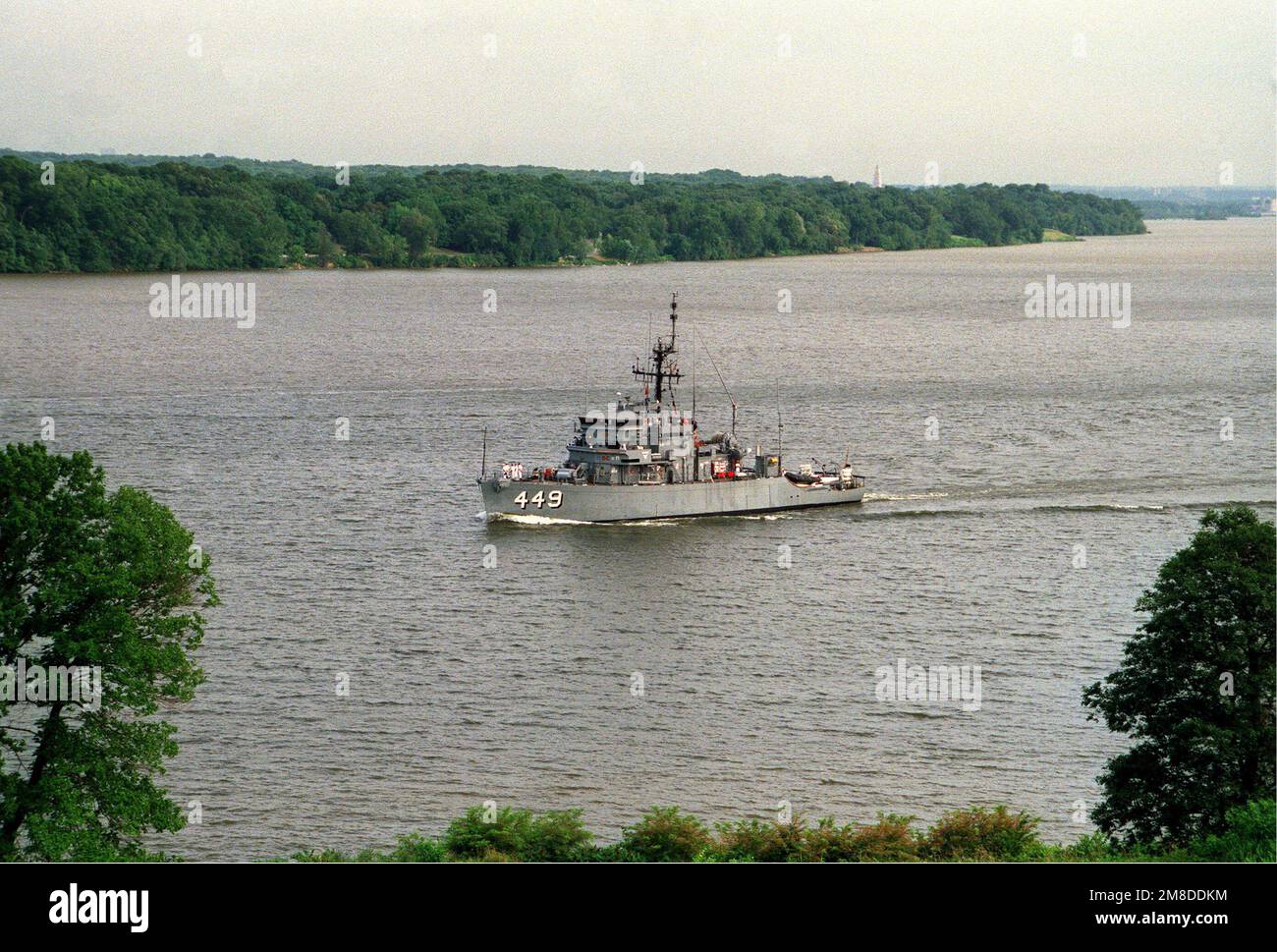 A port view of the ocean minesweeper USS IMPERVIOUS (MSO 449) as seen ...