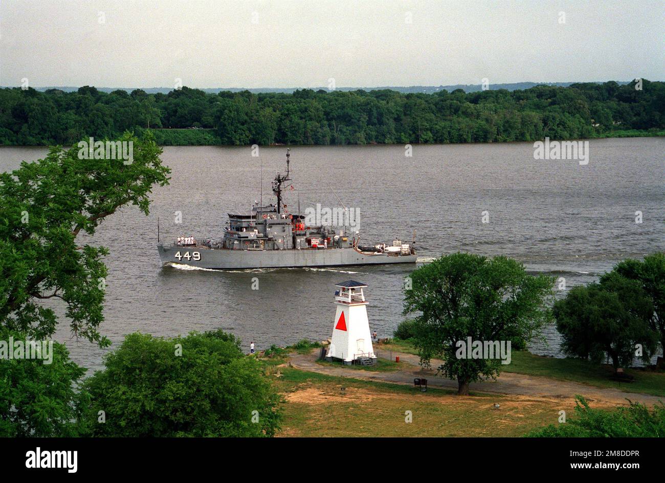 A port view of the ocean minesweeper USS IMPERVIOUS (MSO 449) as the ...