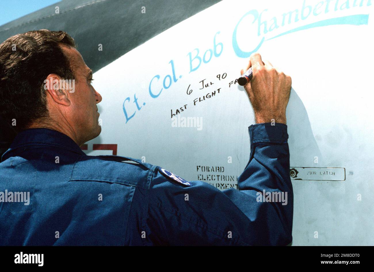 Gary Olin of Rockwell International writes the date of its final flight ...