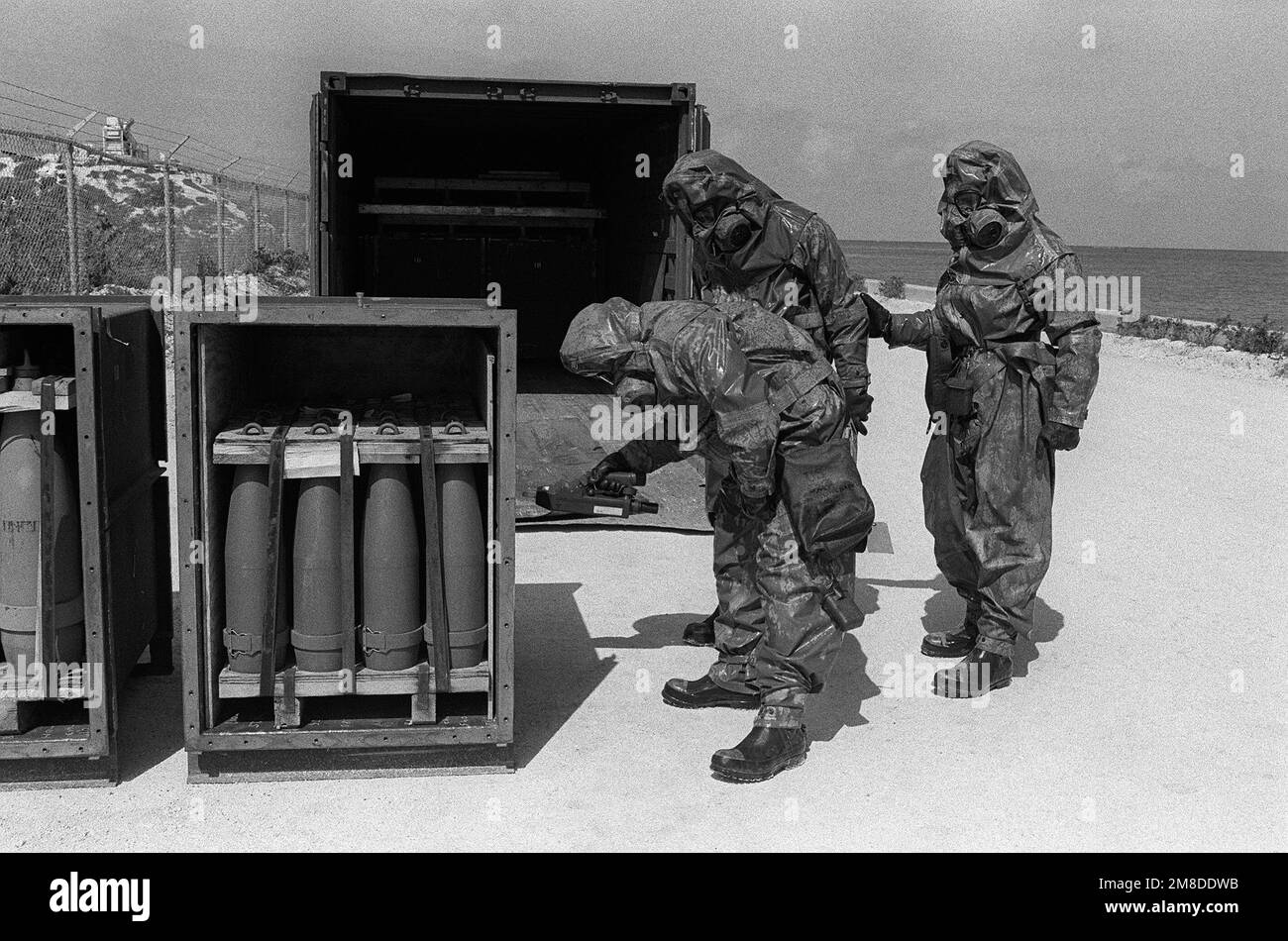 Wearing full protective gear, a soldier from the 71st Chemical Regiment ...