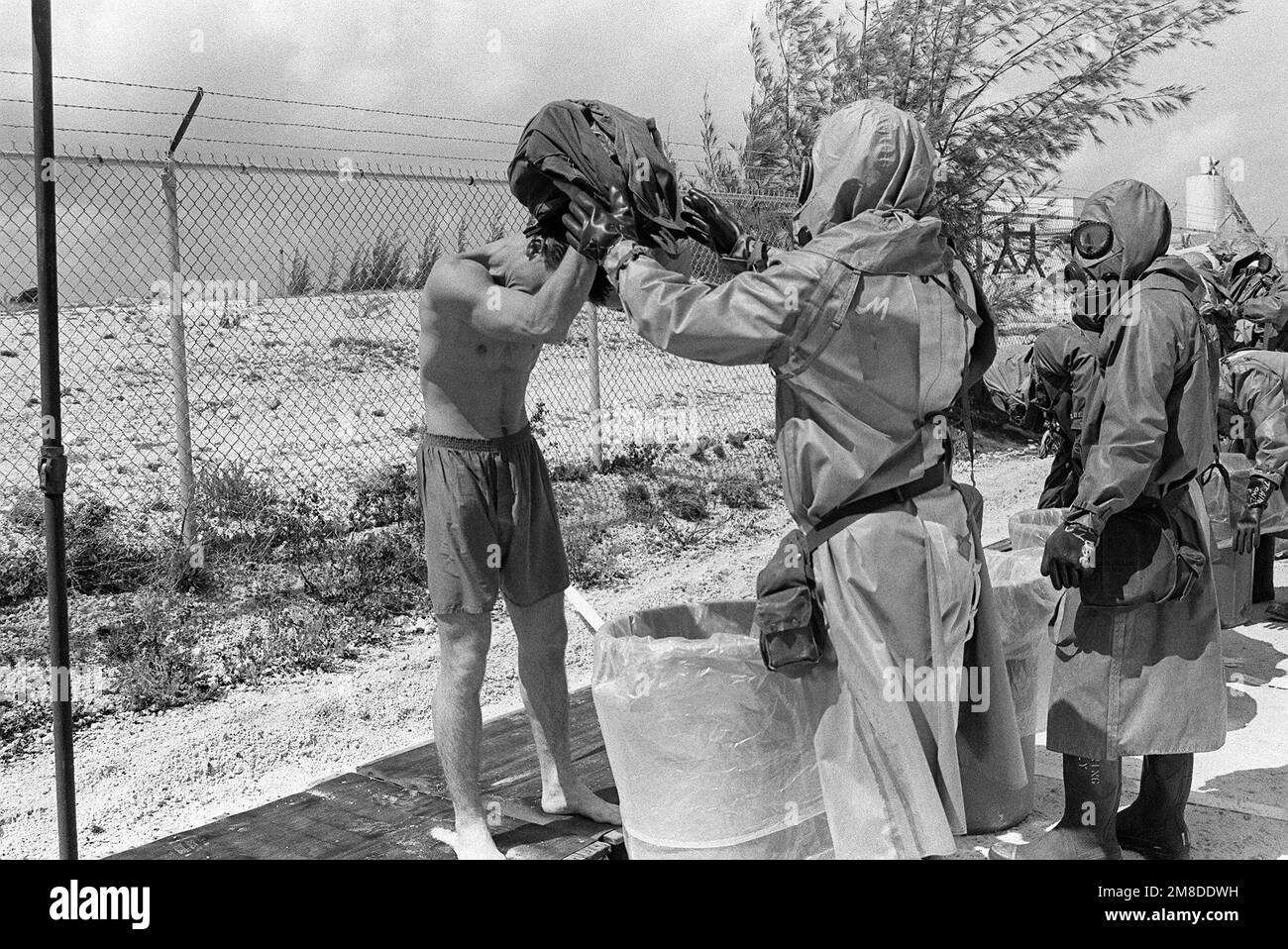 A soldier removes the last layer of his protective clothing at a ...