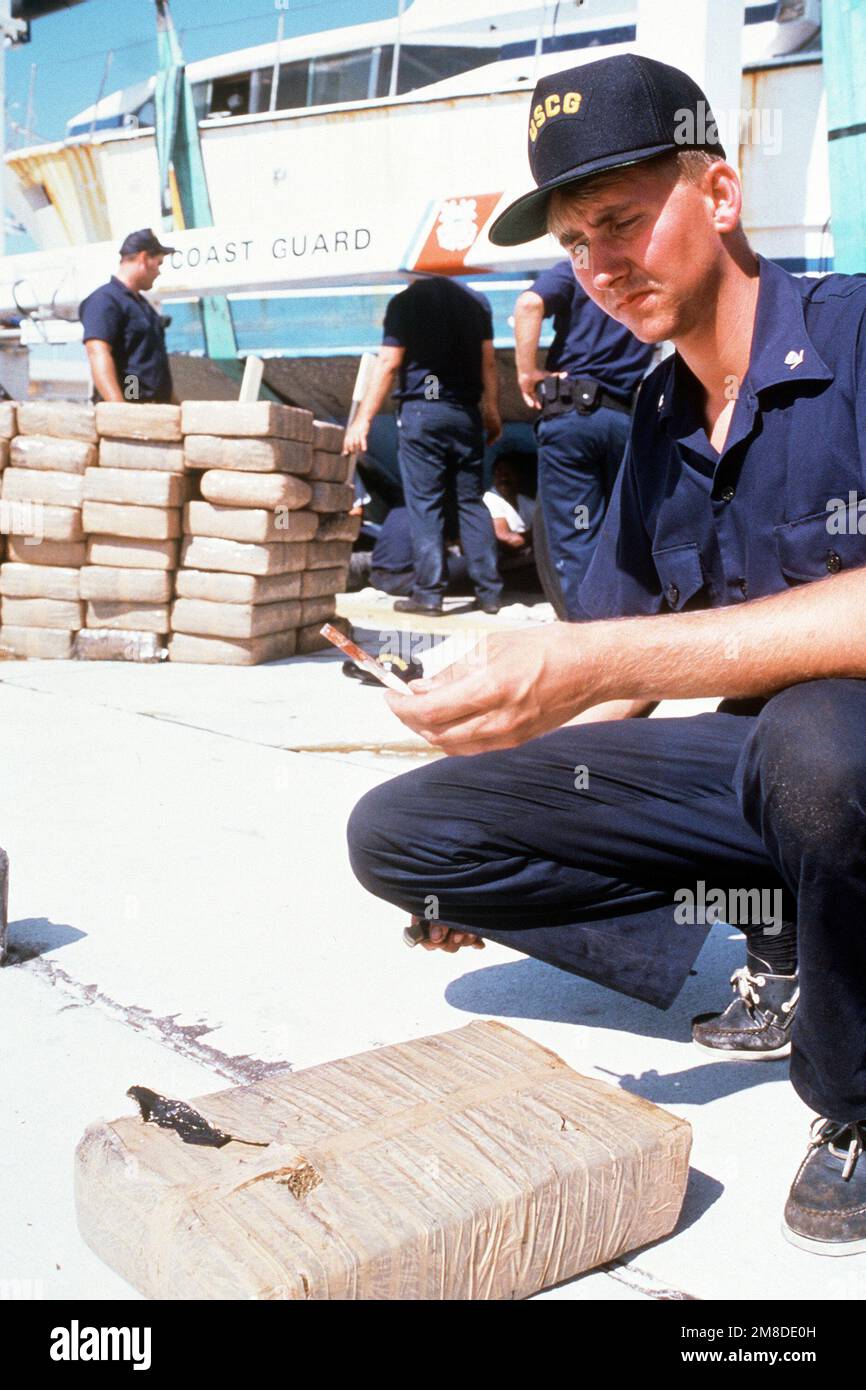 A member of a Coast Guard law enforcement detachment inspects possible ...