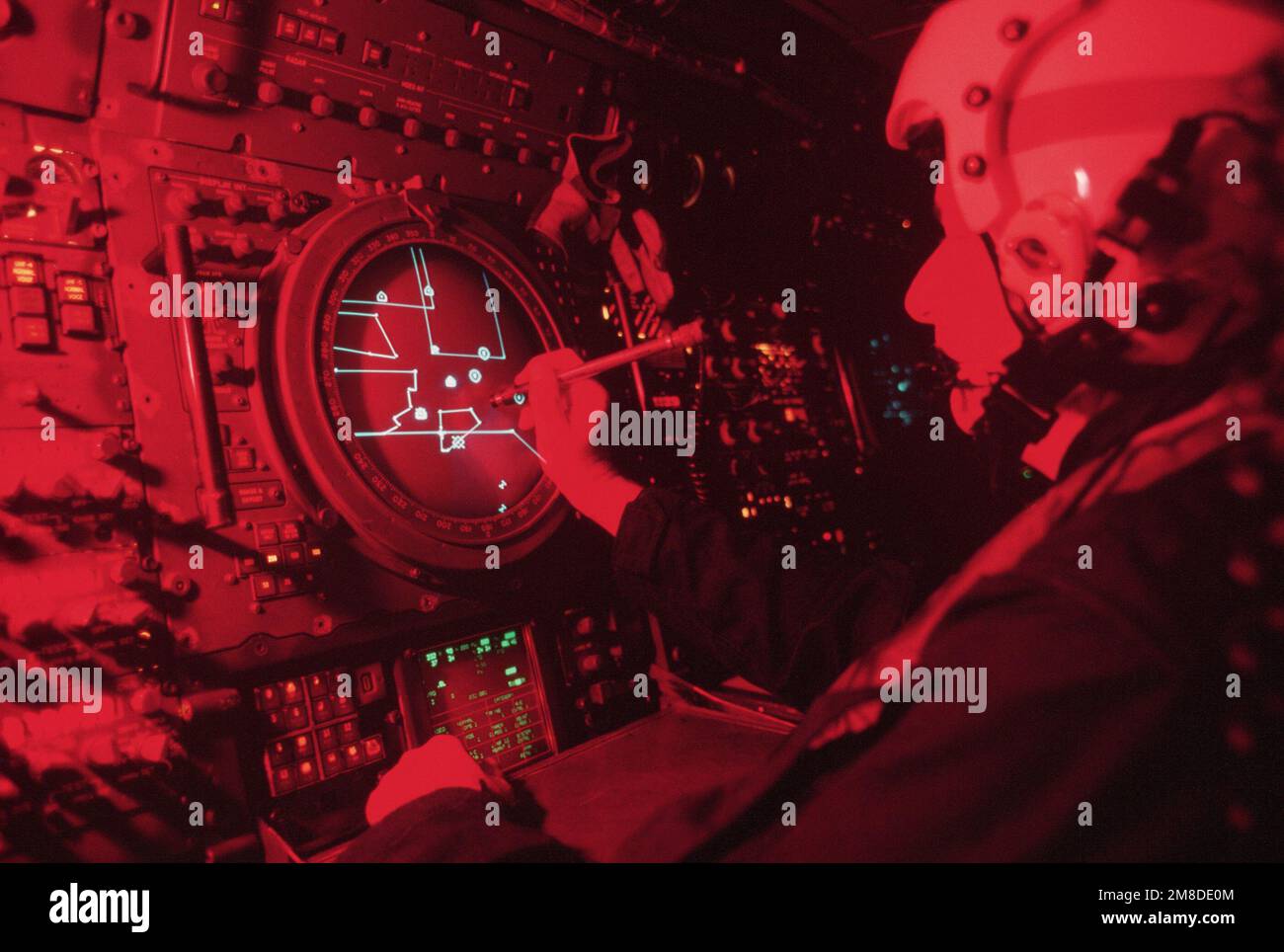 A crewman on an E-2C Hawkeye aircraft tracks vessel movements with his ...