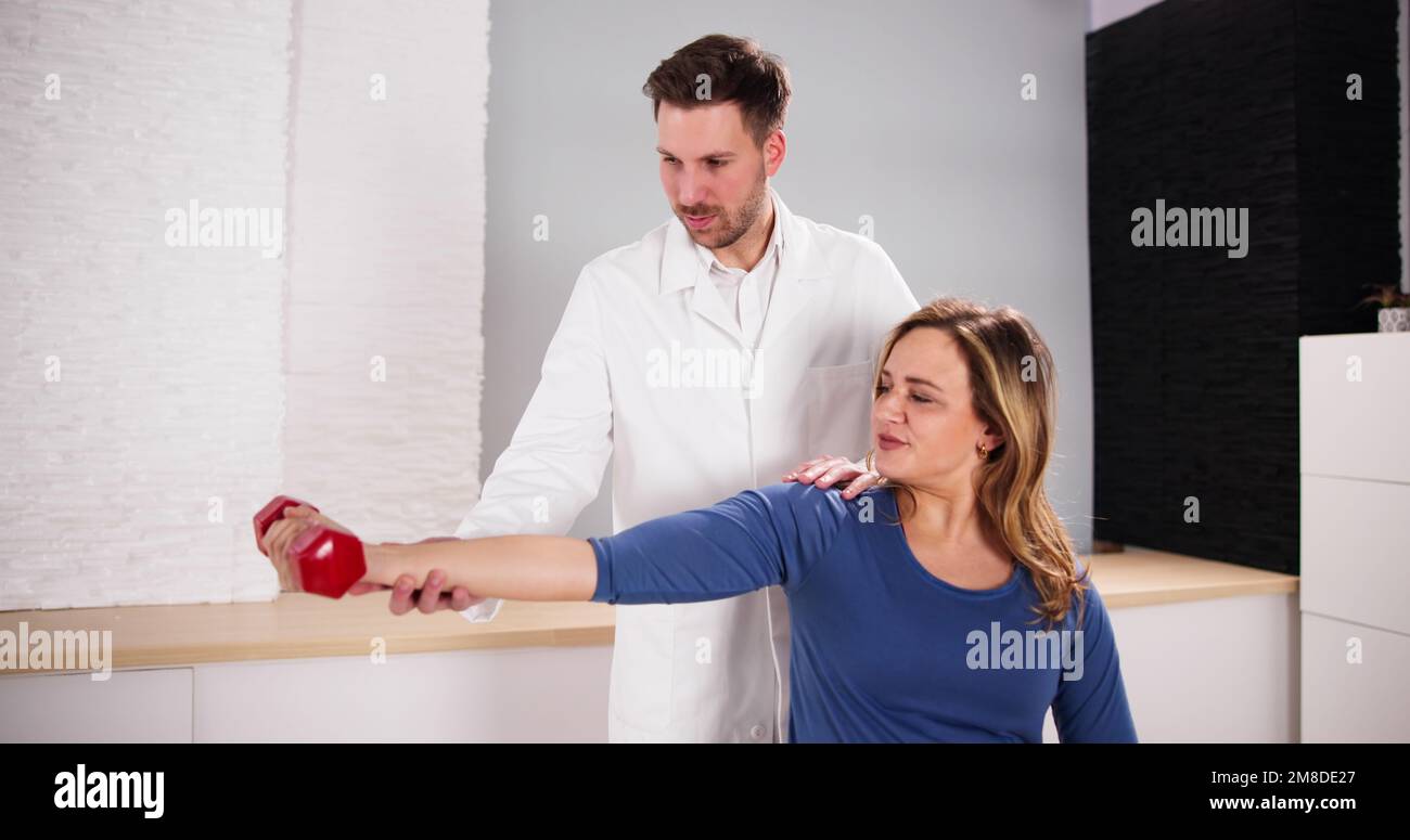 Physical Rehabilitation Therapist Helping Man. Physiotherapy ...