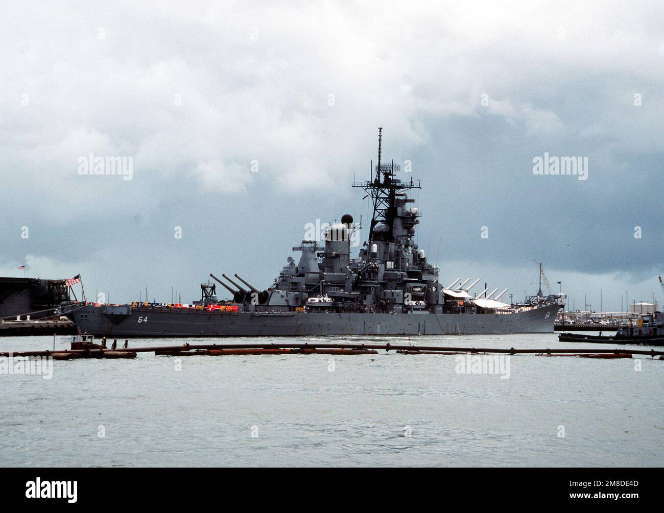 A starboard quarter view of the battleship USS WISCONSIN (BB 64) tied ...