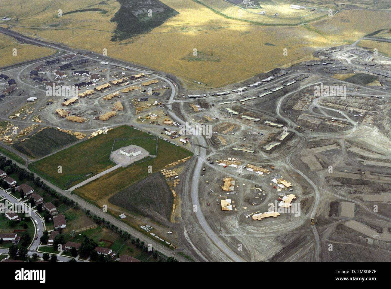 An aerial view of new on-base housing under construction. At lower left ...