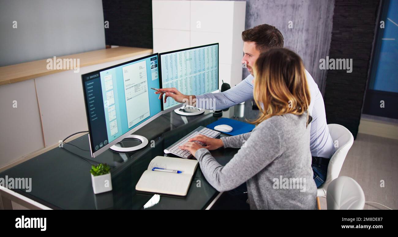 Spreadsheet And Electronic Invoice On Multiple Computer Screens Stock ...