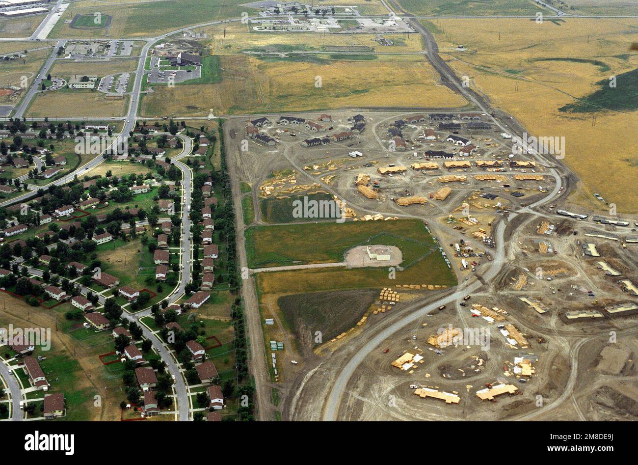 An aerial view of new on-base housing under construction, right, and ...