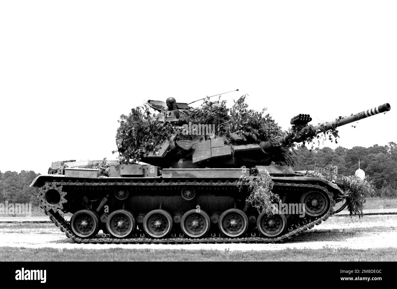 The commander of a Marine M-60A1 main battle tank traverses the turret ...