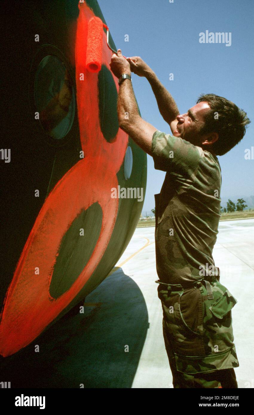 SSGT Jack Combs paints a fluorescent number on a 146th Tactical Air ...